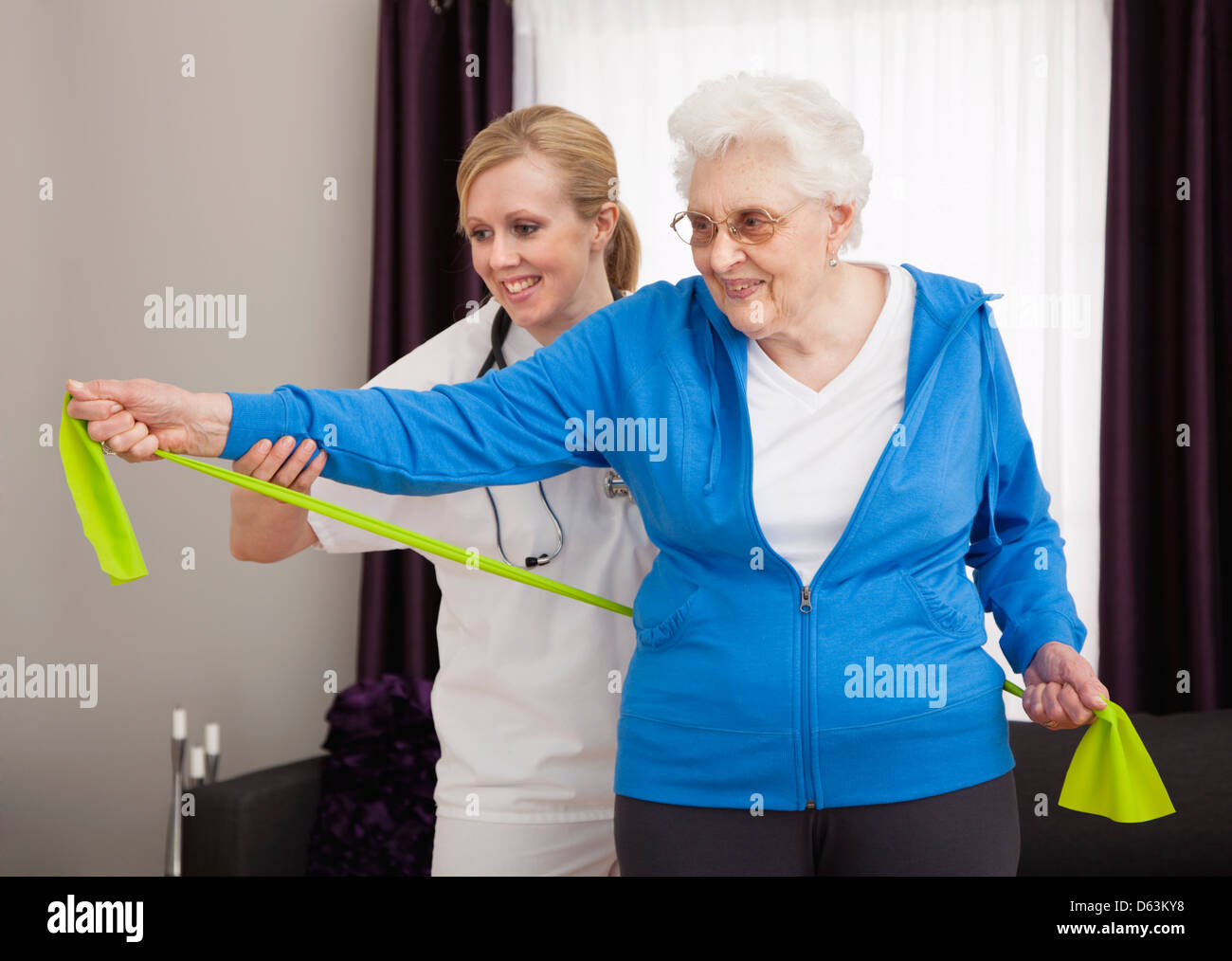 Senior woman exercising with nurse Stock Photo - Alamy