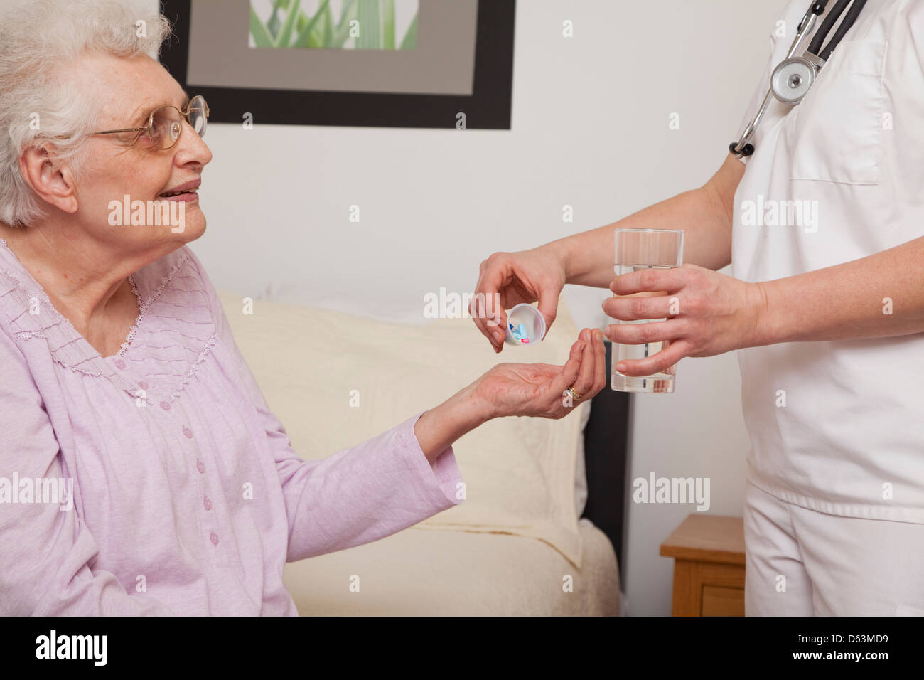 Nurse giving pills to senior patient, close-up Stock Photo - Alamy