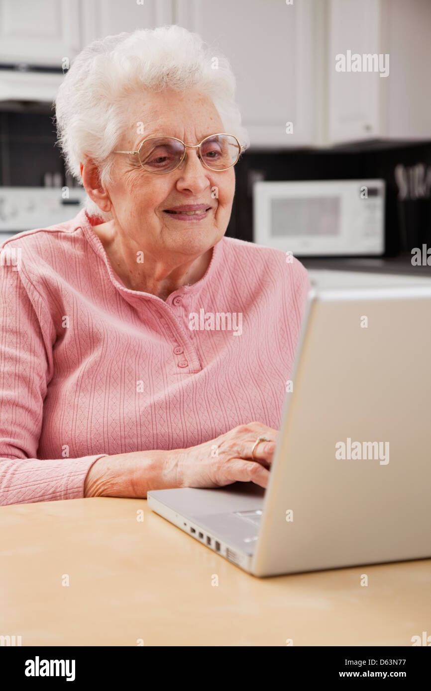Senior woman using laptop Stock Photo - Alamy