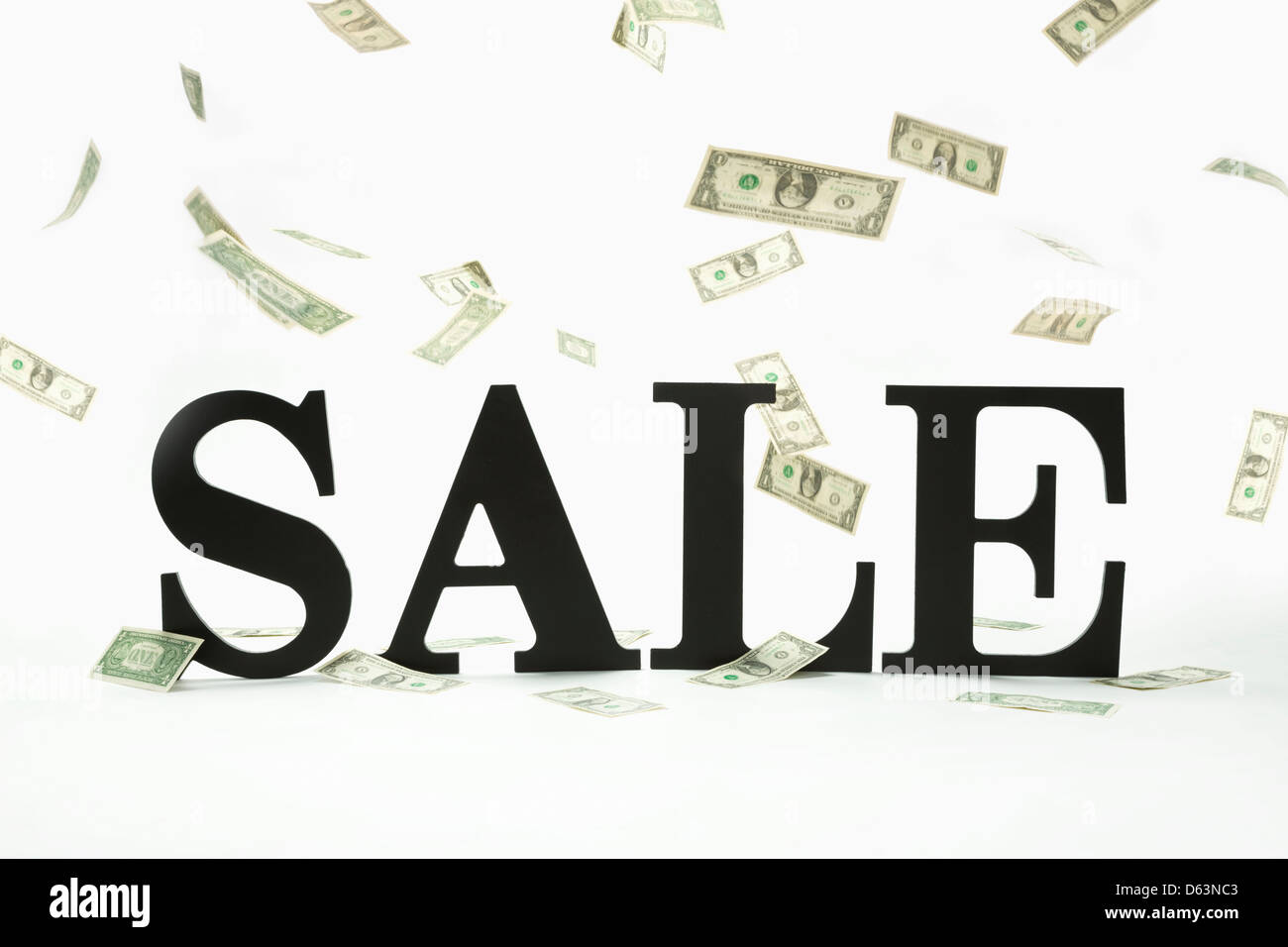 Sale sign and floating dollar bills Stock Photo - Alamy