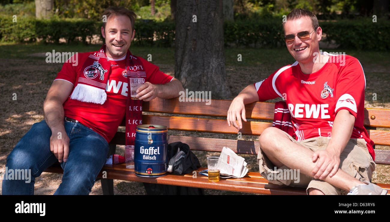 Visiting football fans enjoy a pre-game drink in the park, Frankfurt ...