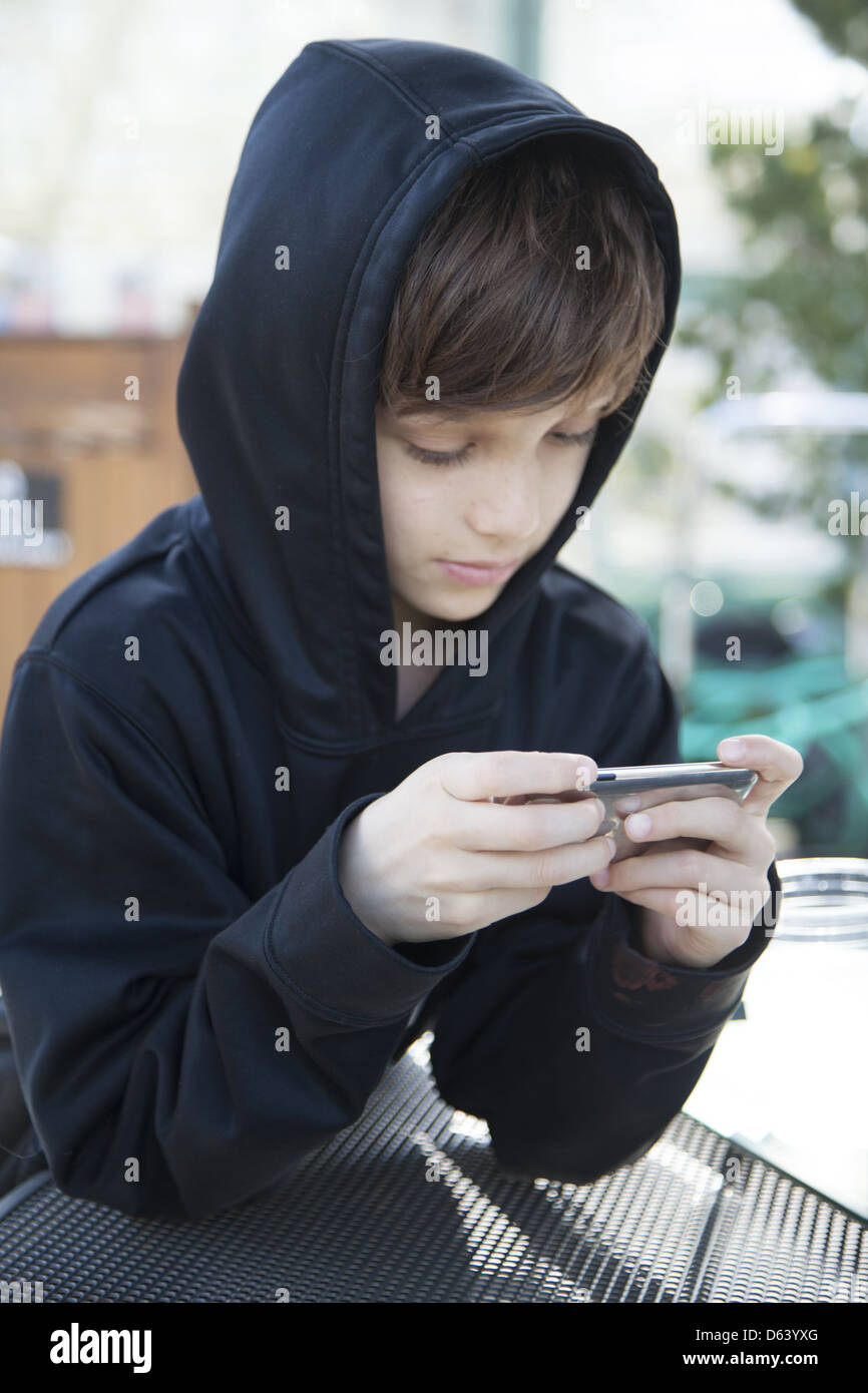 9 year old boy plays Minecraft on his ipod Stock Photo - Alamy