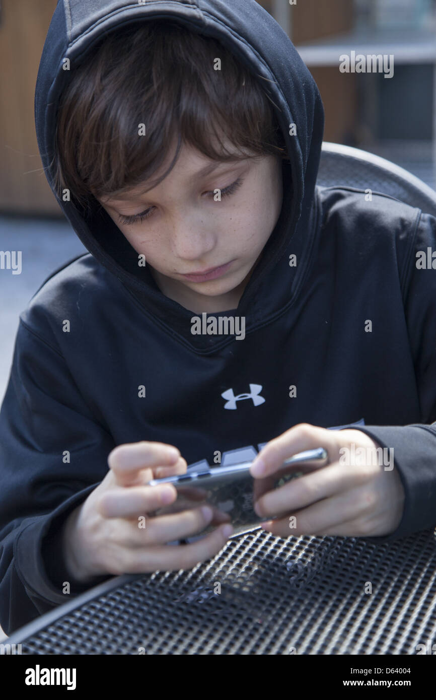 9 year old boy plays Minecraft on his ipod Stock Photo - Alamy