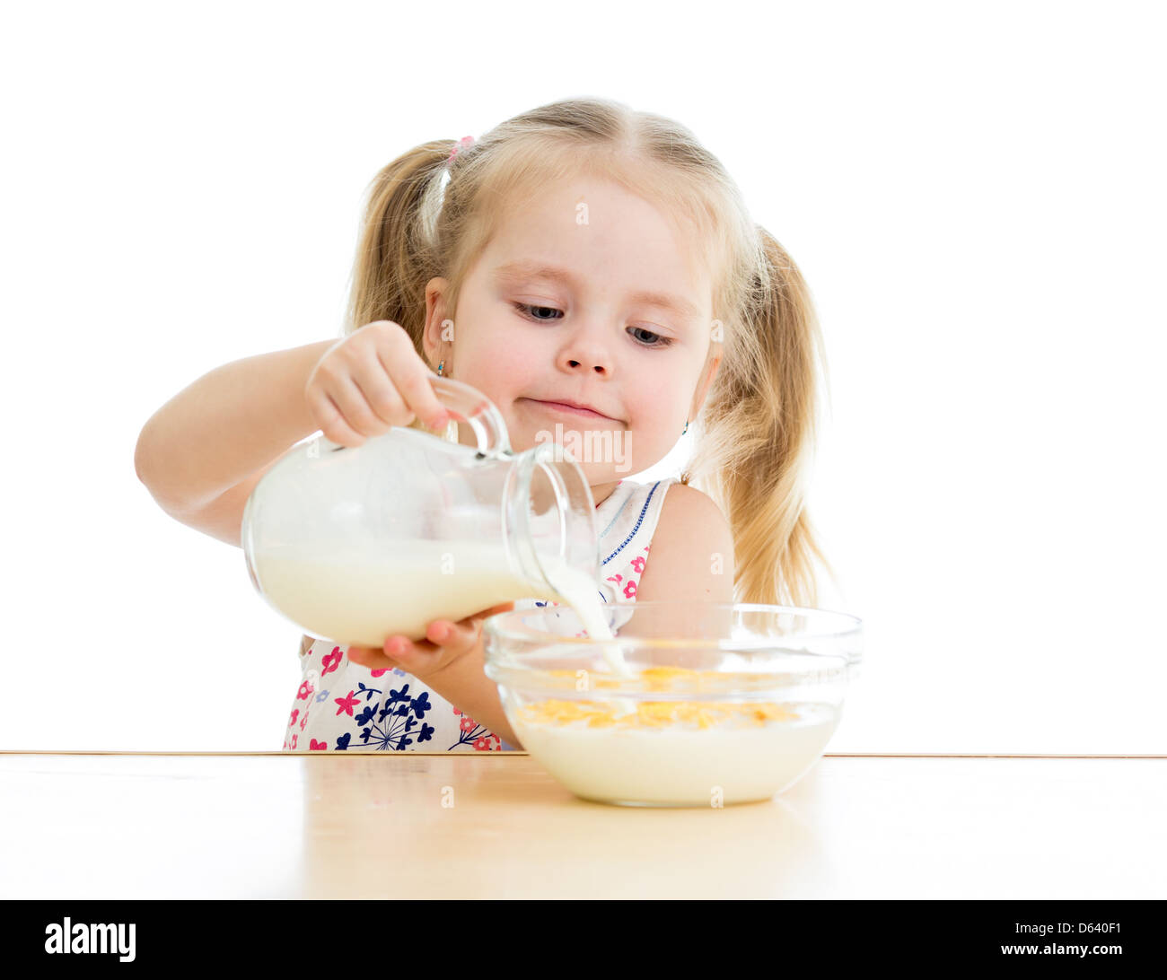 kid girl preparing corn flakes with milk Stock Photo - Alamy