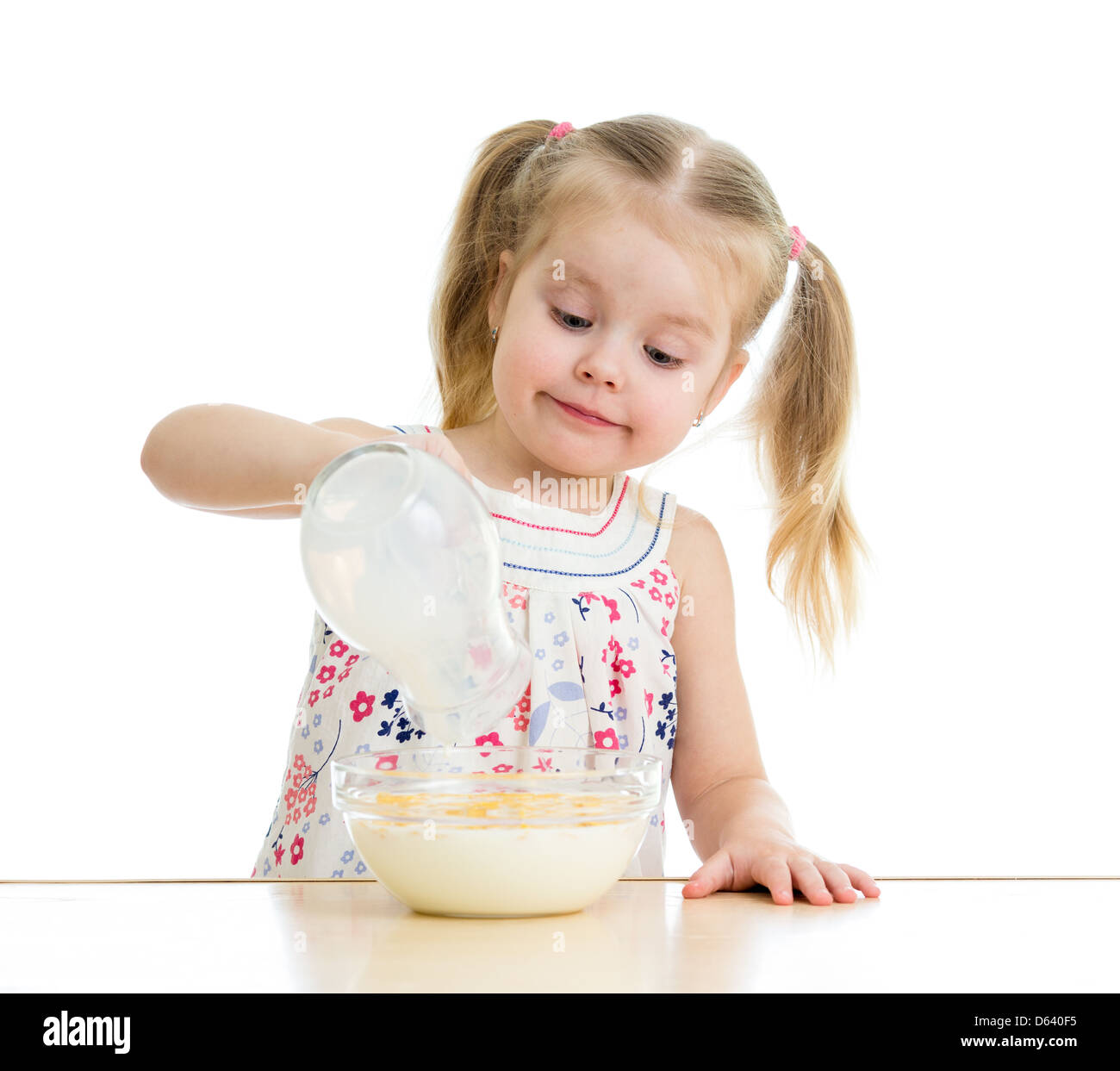 kid girl preparing corn flakes with milk Stock Photo - Alamy