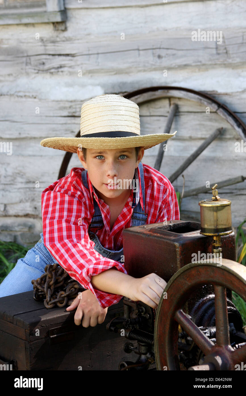 A young farmer boy working on a steam engine machine Stock Photo - Alamy