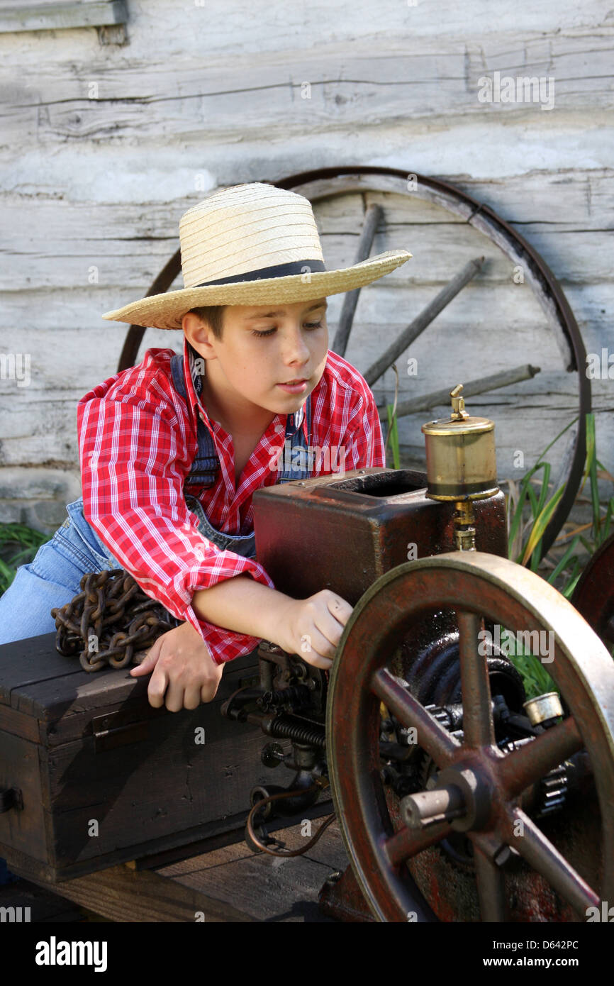A young farmer boy working on a steam engine machine Stock Photo - Alamy