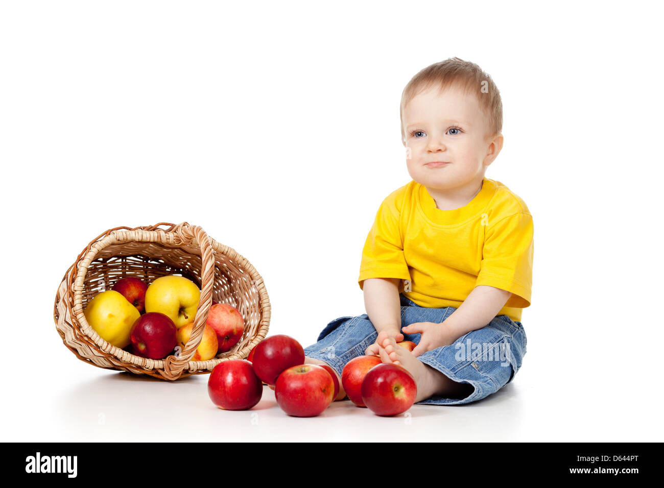 Funny child with basket filling apples Stock Photo - Alamy