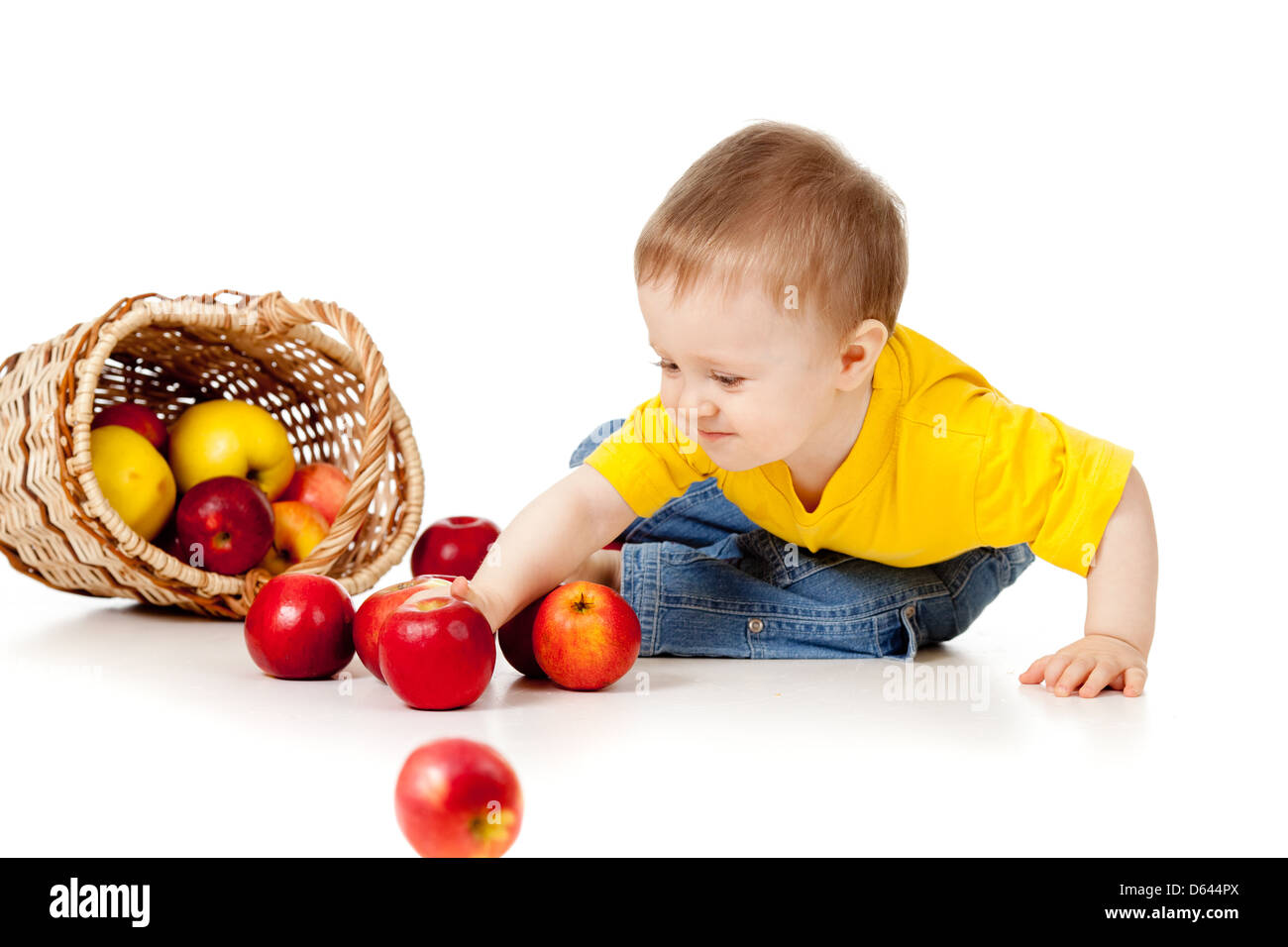 Funny child with basket filling apples Stock Photo - Alamy