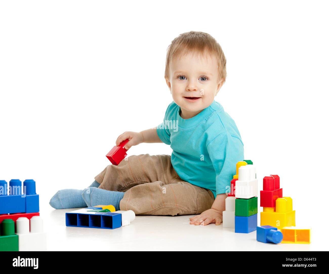 little cheerful child with construction set over white background Stock ...