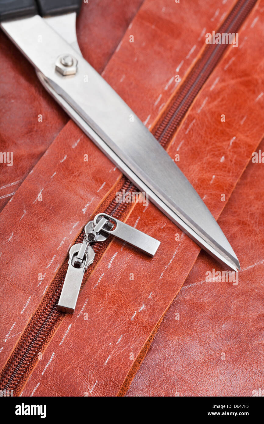 tailor shears and zip runners on details of brown leather pattern Stock ...