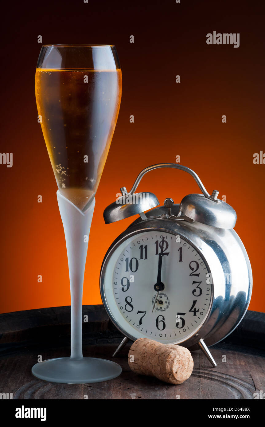 glass of champagne and old watch showing twelwe o´clock Stock Photo - Alamy