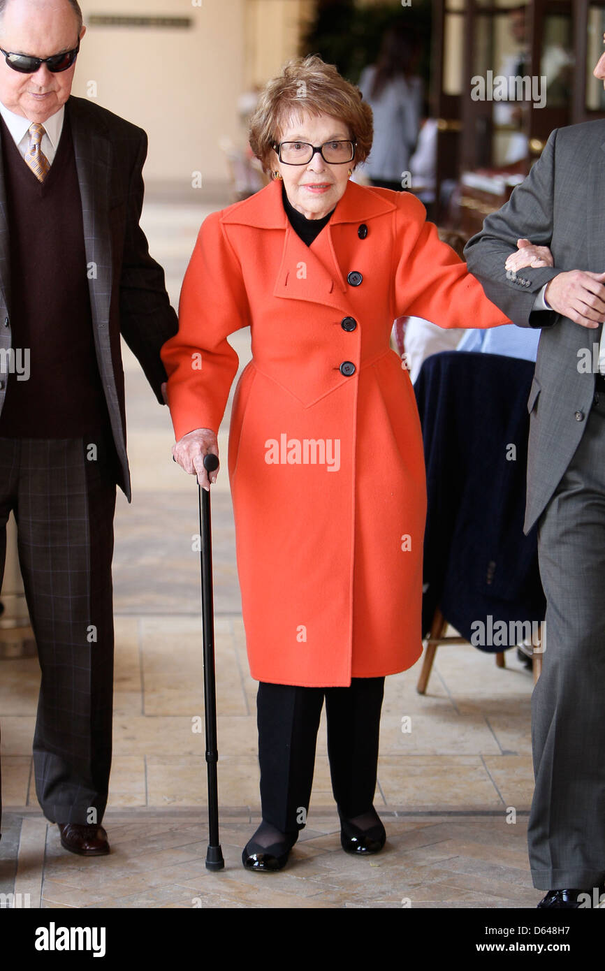 Nancy Reagan wearing a red jacket as she leaves a restaurant in Beverly ...