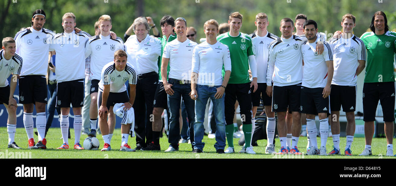 German Formula One racing drivers Michael Schumacher (C-L) and Nico ...