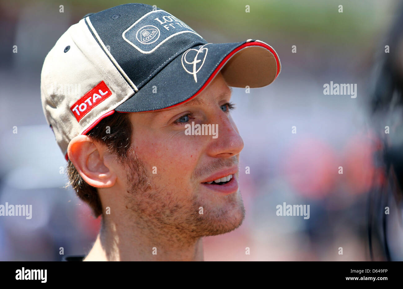 French Formula One driver Romain Grosjean of Lotus walks through the ...