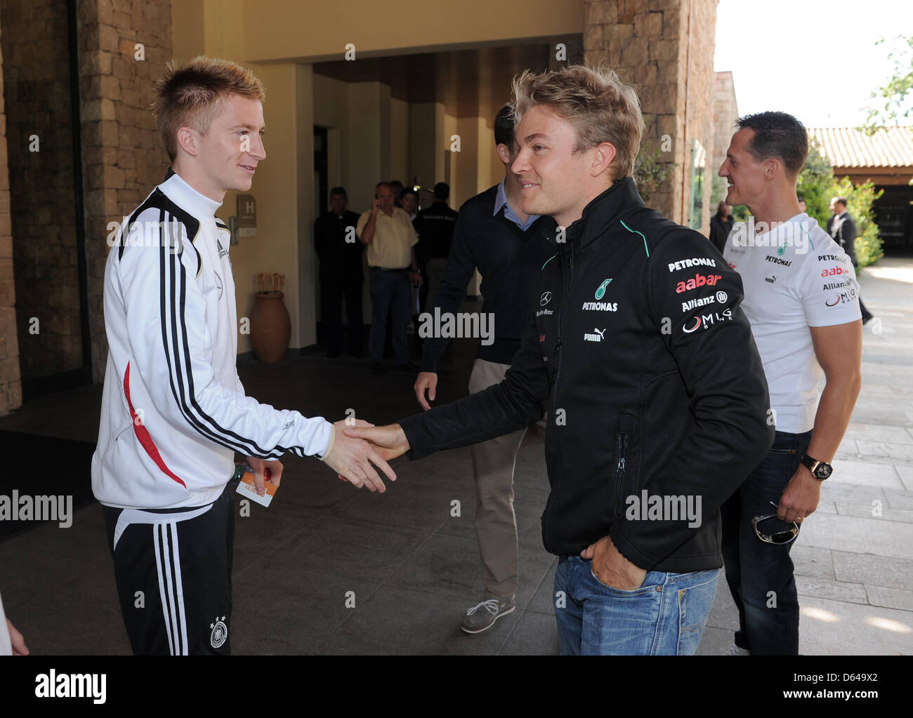 German national soccer team player Marco Reuss (L) greets Formula One ...