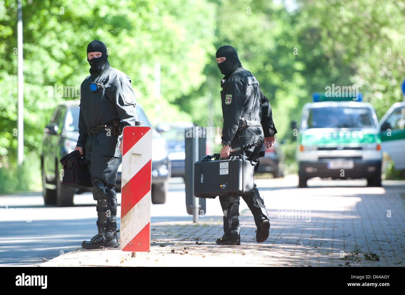 Police with face masks stand at the gate of Hells Angels president ...