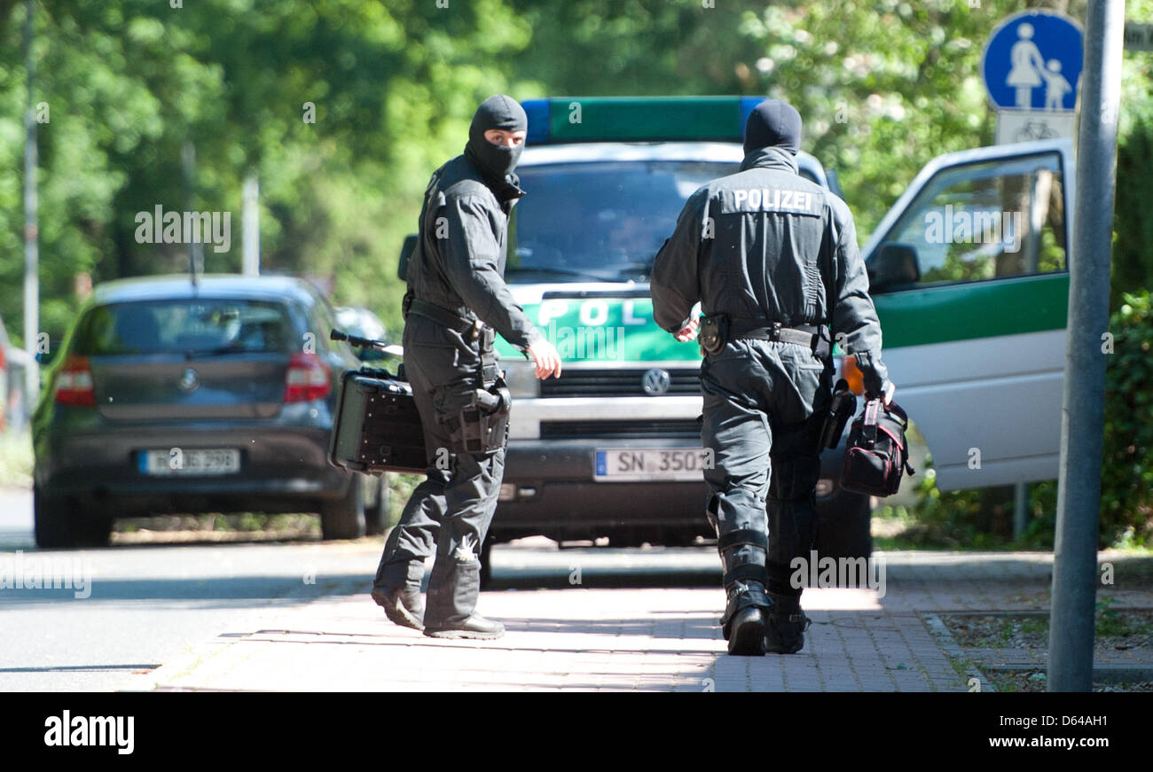Police with face masks stand at the gate of Hells Angels president ...