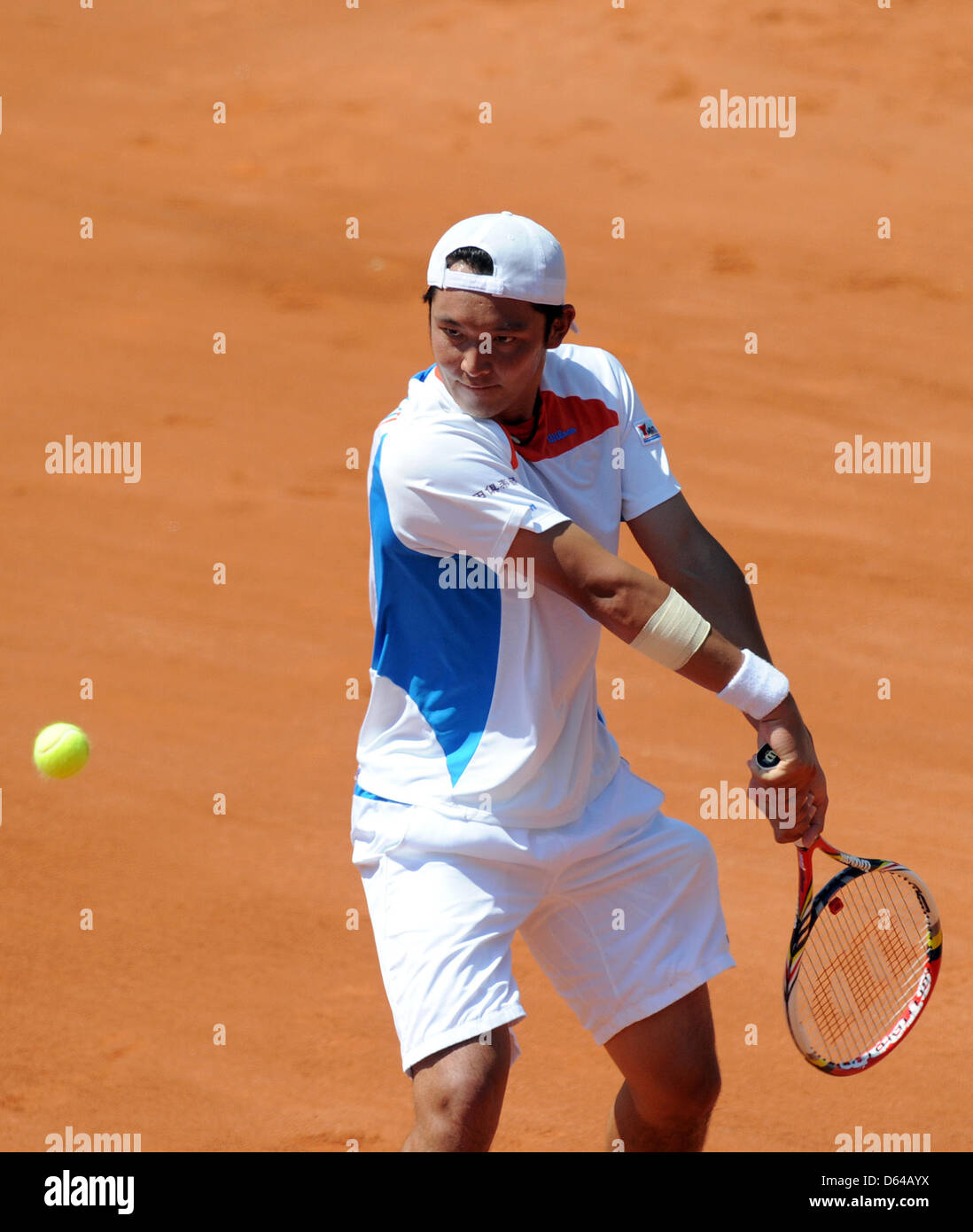 Japanese tennis player Tatsuma Ito hits the ball in a match against ...