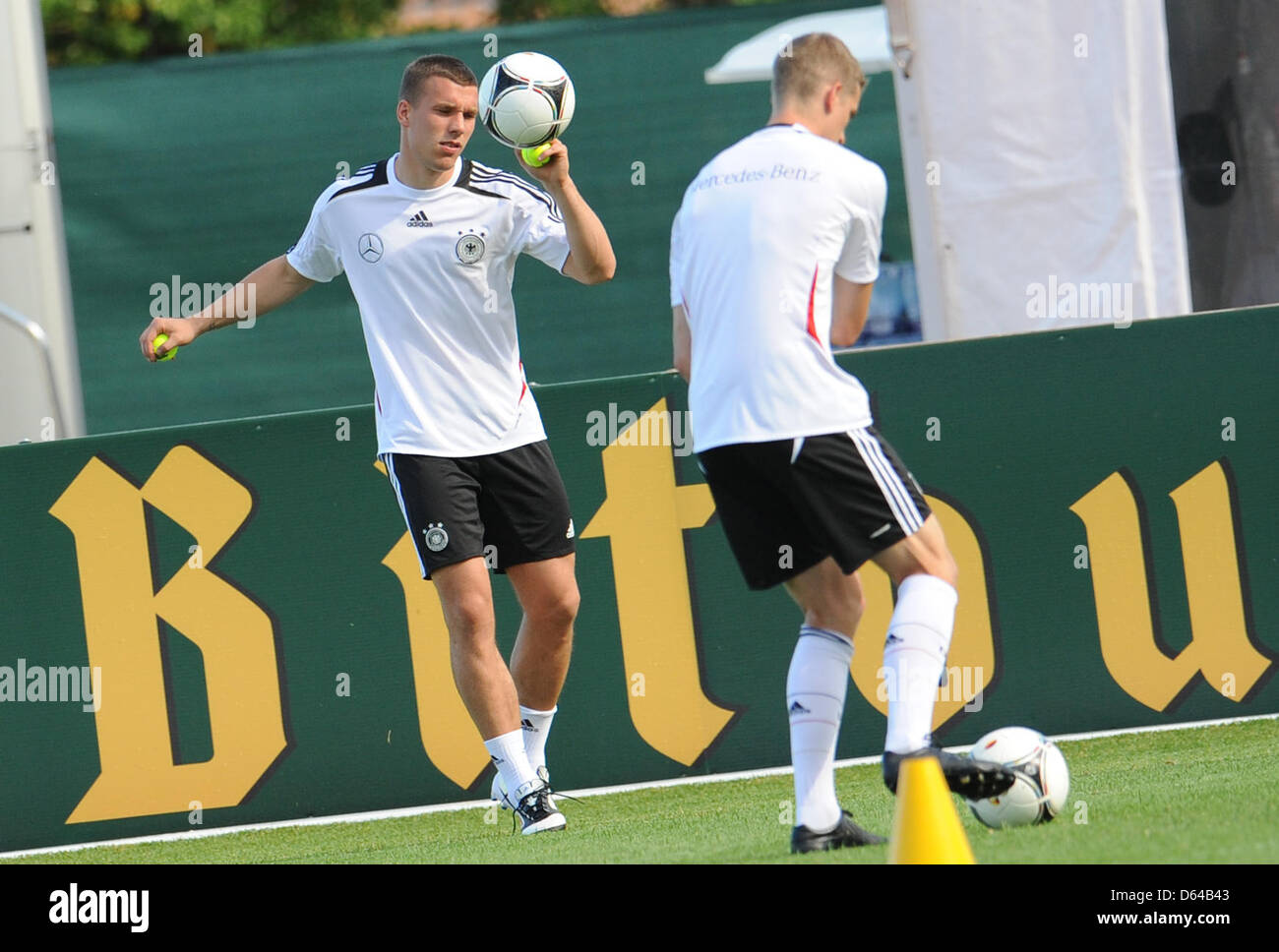 German national soccer players Lukas Podolski (L) and Lars Bender are ...