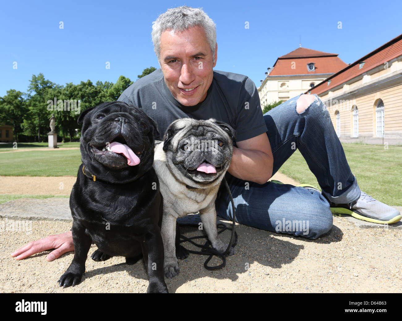 Actor Ralph Herforth poses with the two pugs Djego and Felix (L) in ...