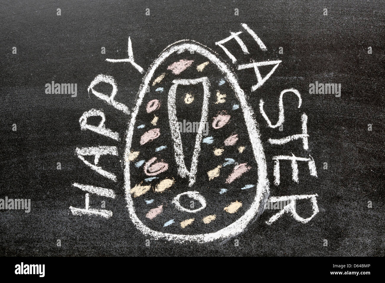 happy easter phrase handwritten on the school blackboard around painted ...