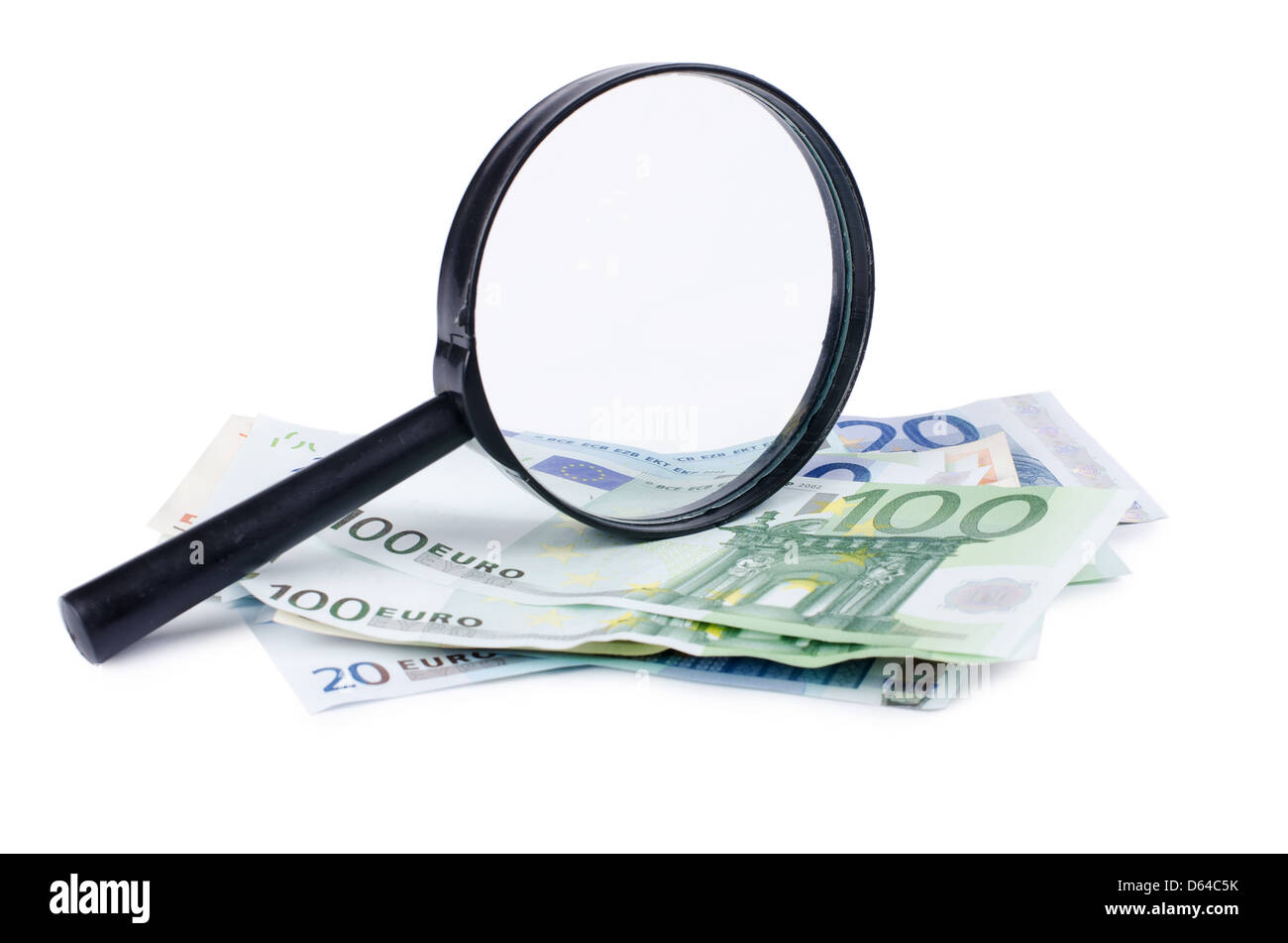 Magnifying glass lying on banknotes Stock Photo - Alamy