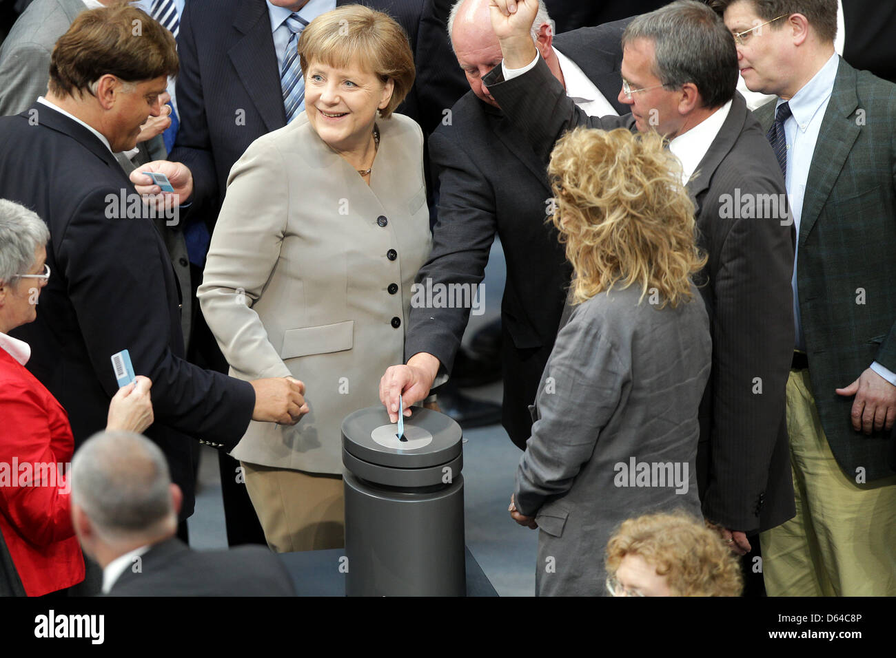 German Chancellor Angela Merkel (4-L) casts a vote during a ...