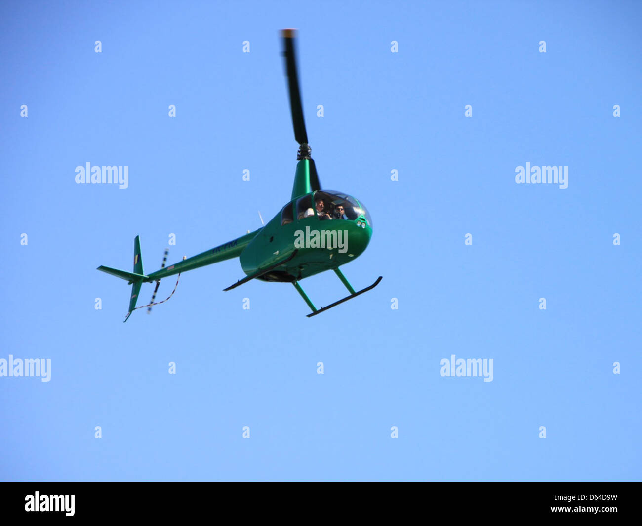 A helicopter is captured flying through the sky, showcasing the flight ...