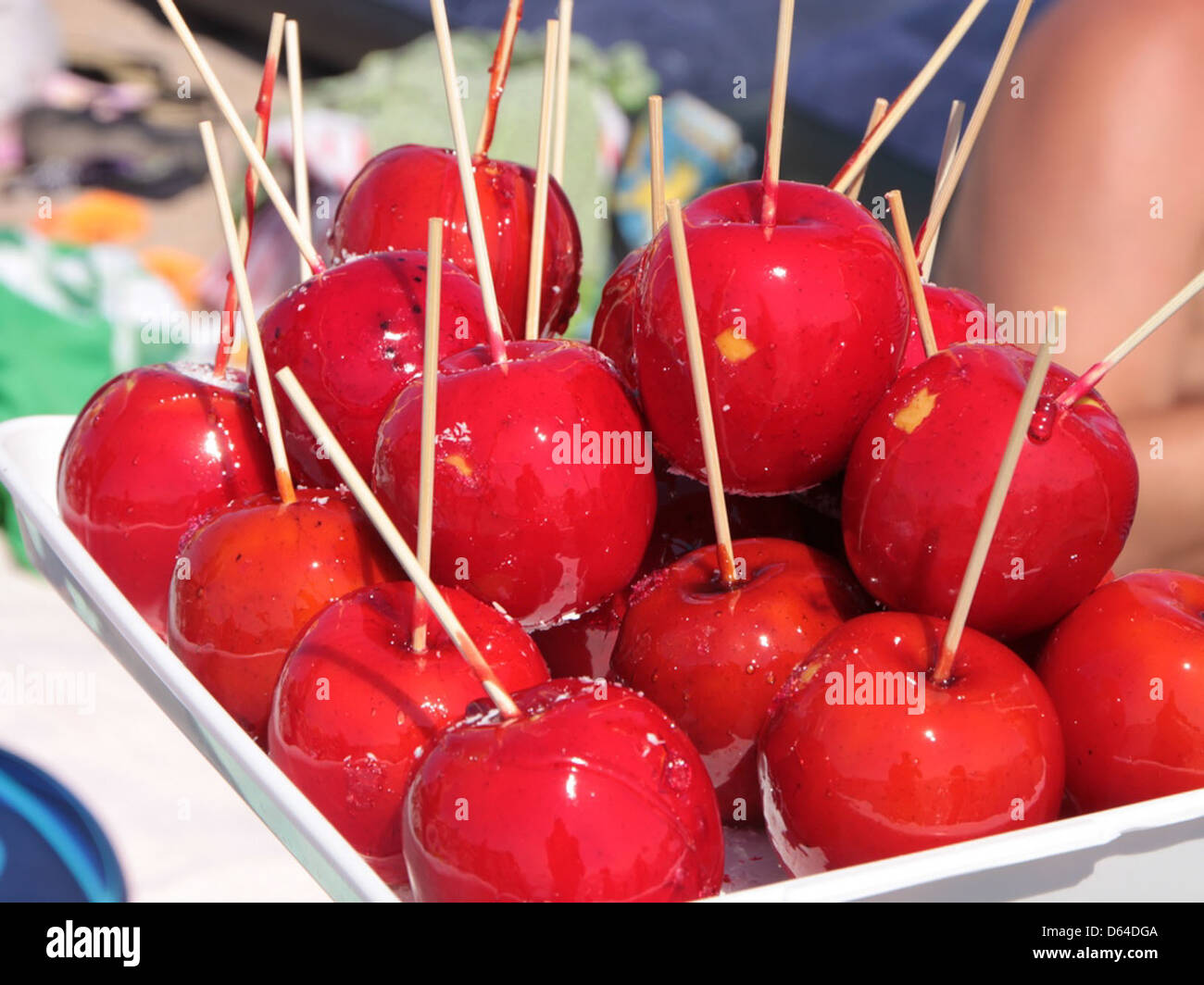 This image features a group of red toffee apples, a popular treat made ...