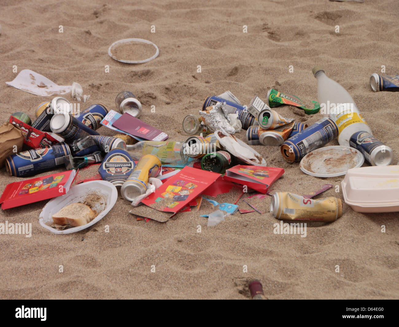 An image showing trash and garbage collected along a beach. The debris ...