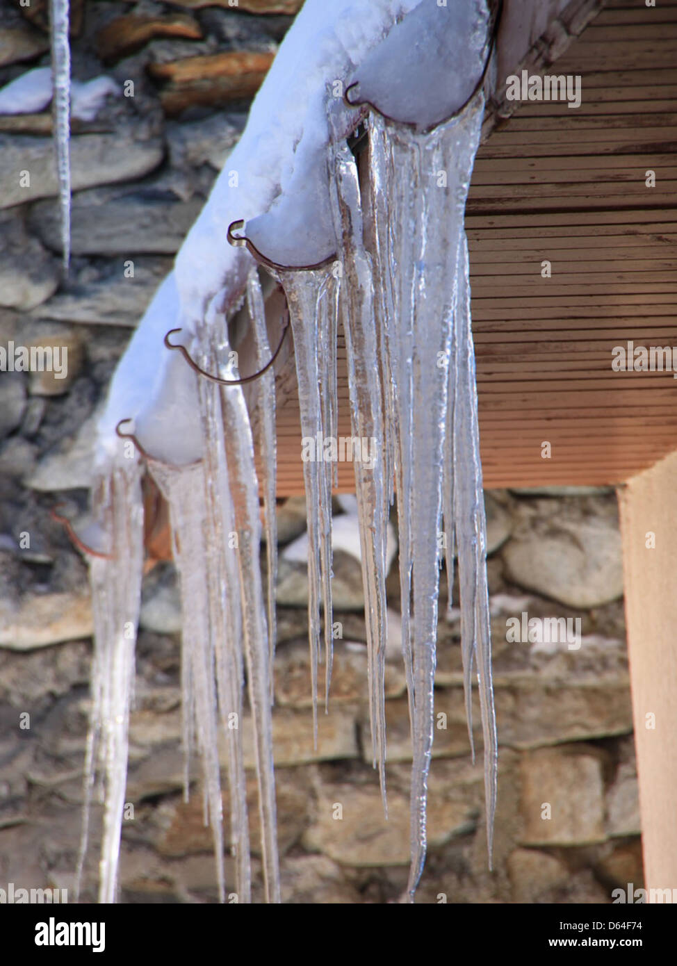 Icicles hanging from an ice dam, formed as water drips and freezes in ...