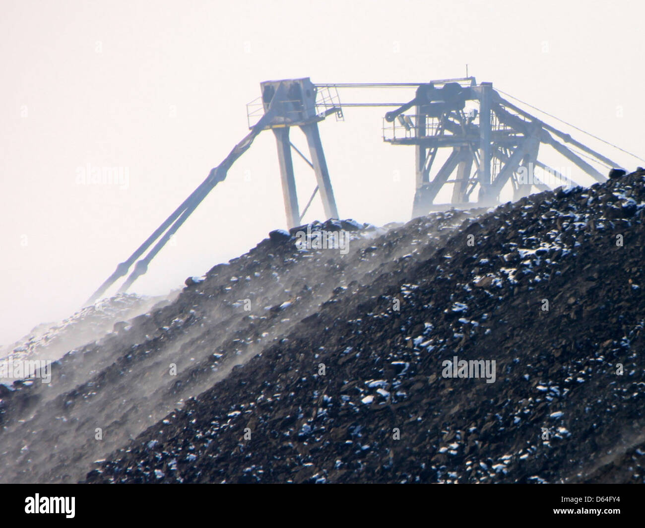 Smoke rising from a coal mining deposit, depicting the environmental ...