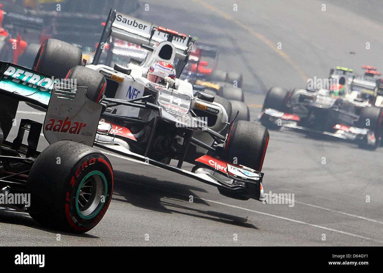 Japanese Formula One driver Kamui Kobayashi (C) of Sauber jumps with ...