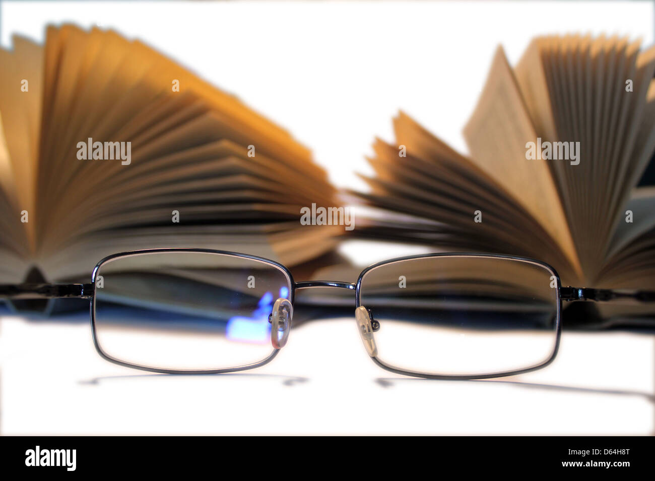 Books through the glasses on the white background Stock Photo - Alamy