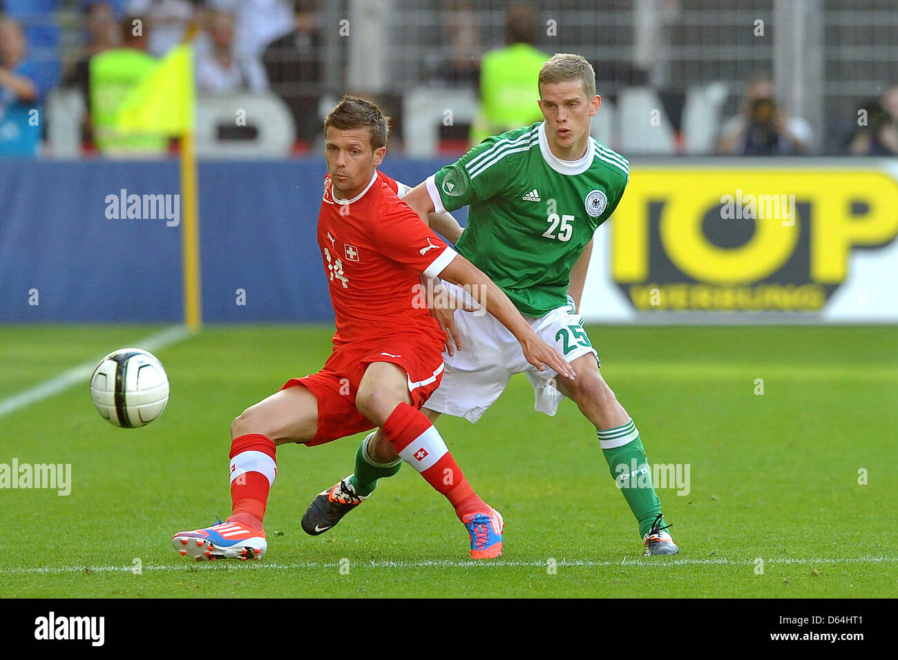 Switzerland's Valentin Stocker (front) vies for the ball with Germany's ...
