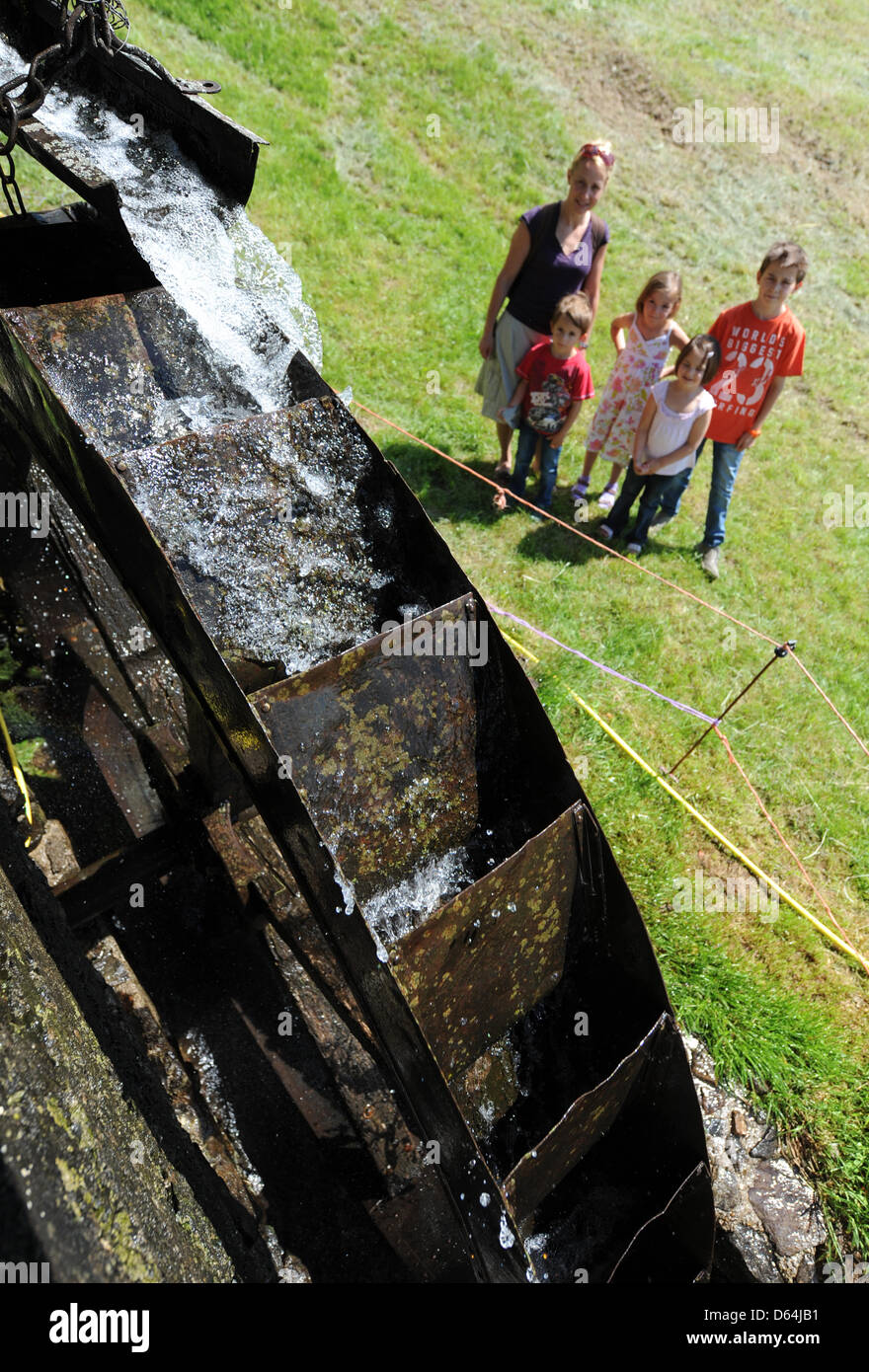 A family watches the old mill wheel at Schoenbachhof Mill in St Peter ...