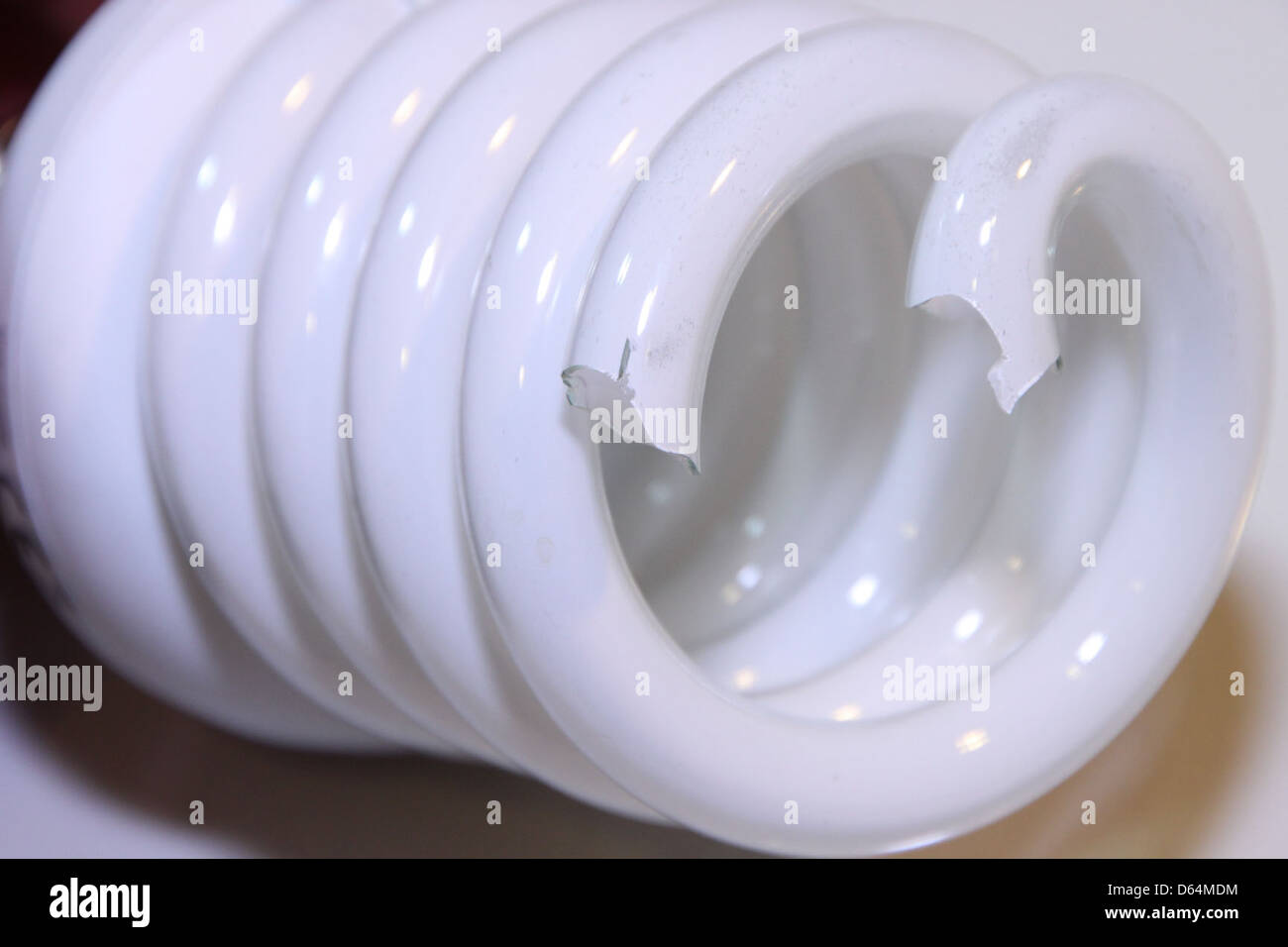 This image shows a broken compact fluorescent lamp (CFL), illustrating ...