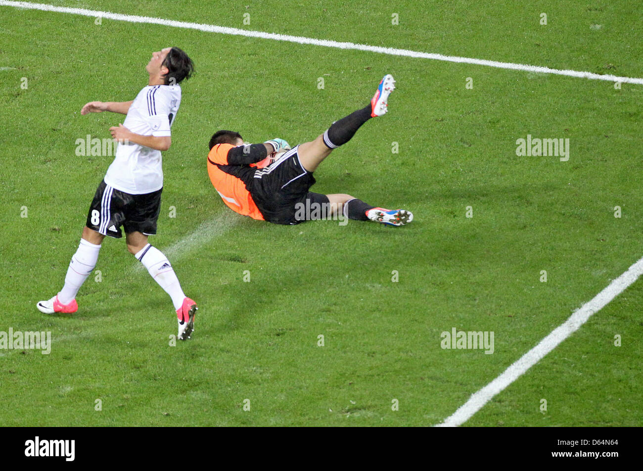 Israel's gaolkeeper Ariel Harush catches the ball next to Germany's ...