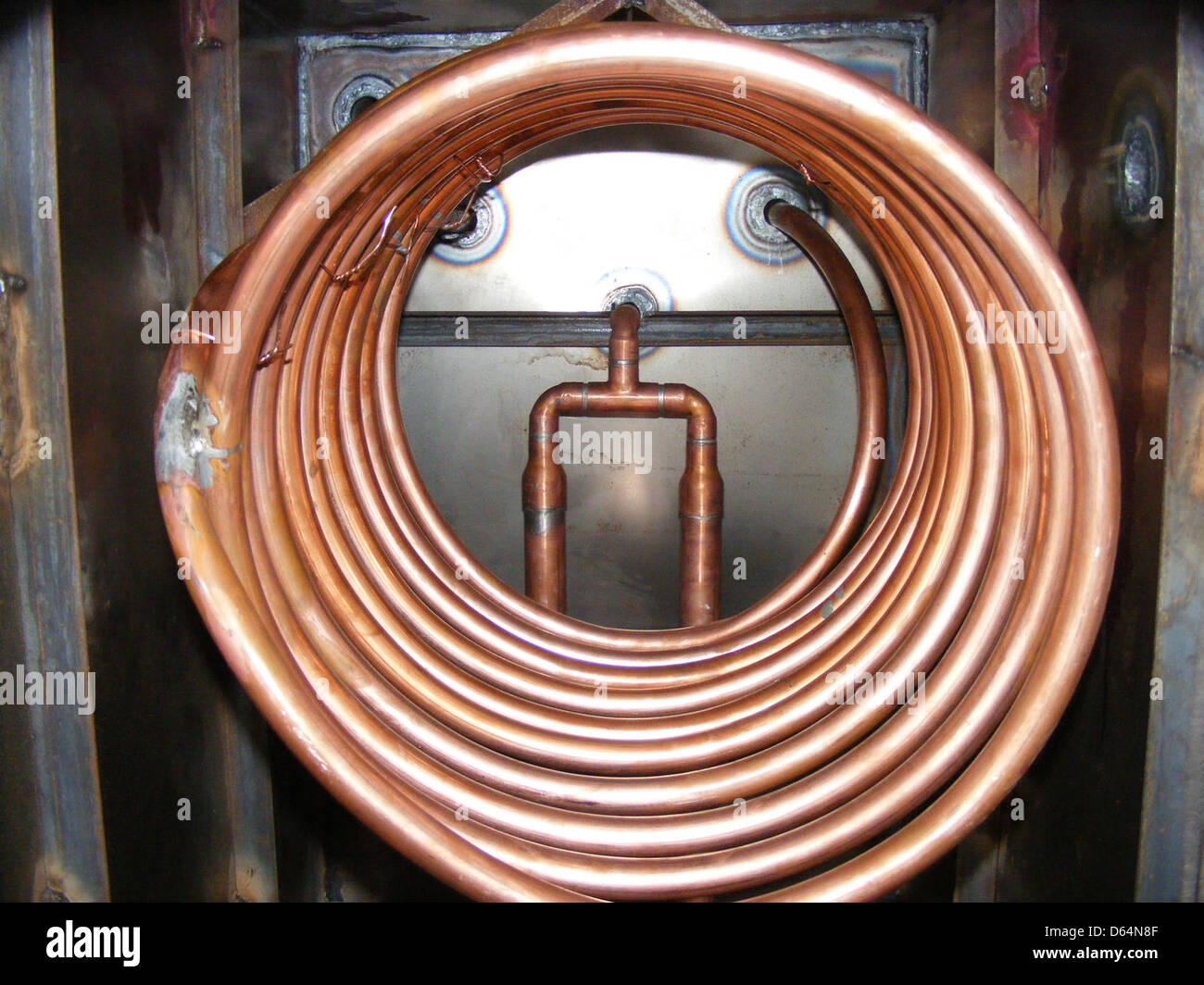 A photo showing a copper coil heat exchanger used in thermal storage ...