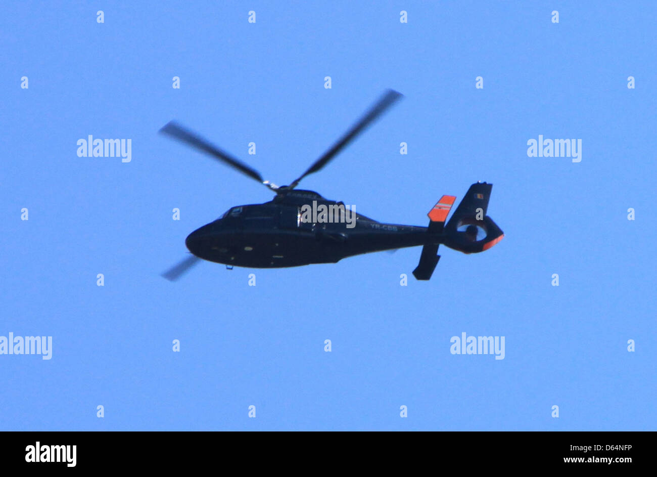 A Black Hawk helicopter in flight against a clear blue sky ...