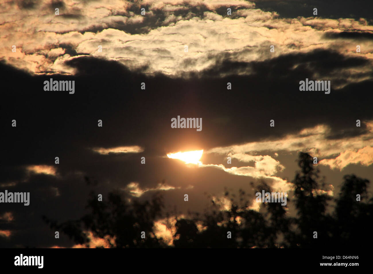 Sun-under-Dark-Clouds-at-Sunset 44173 Stock Photo - Alamy