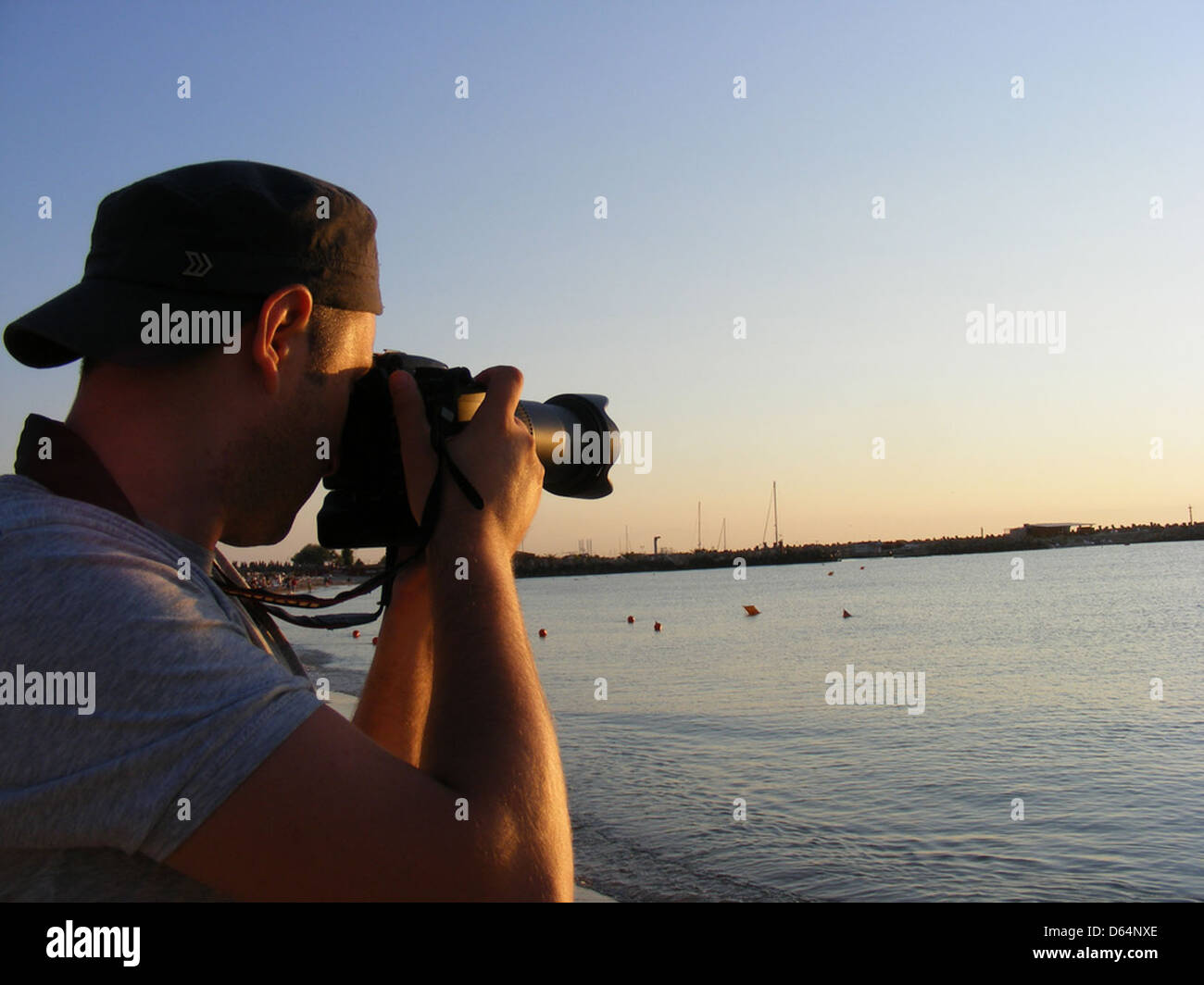 This image shows a photographer capturing the scene on a beach, with ...