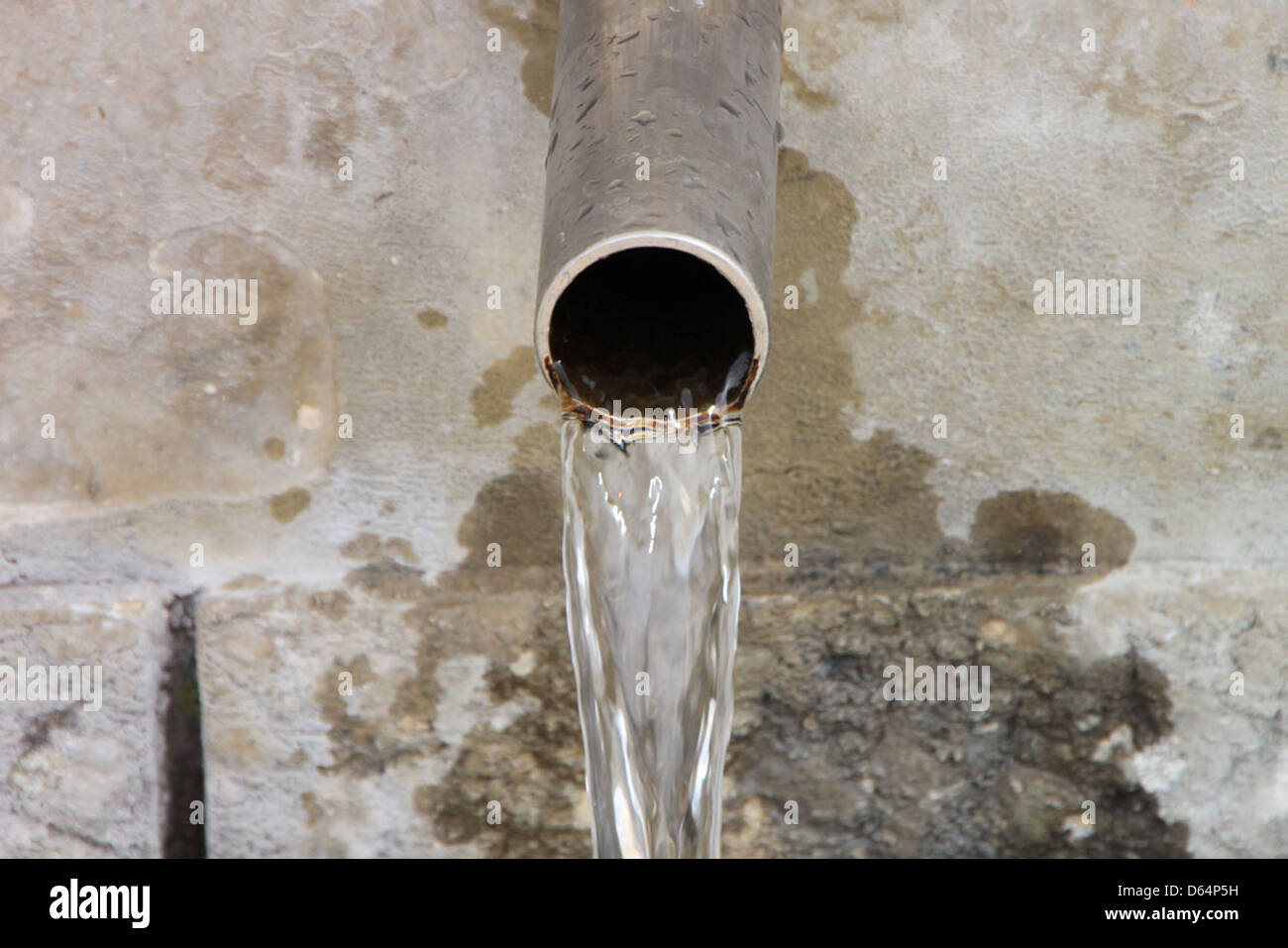 This image depicts clear, fresh water flowing from pipes, showing the ...