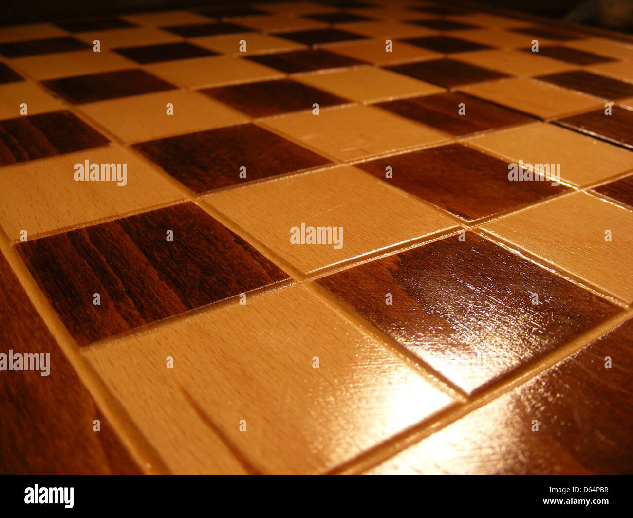 A wooden chessboard featuring carved chess pieces, each detailed with ...