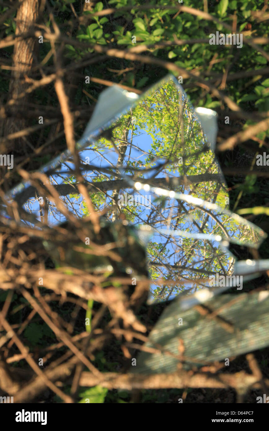 This image showcases a broken mirror with a reflective surface showing ...