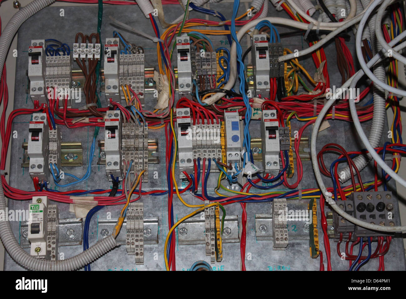 An electrical panel featuring automatic fuses and DIN rail mounts. It ...