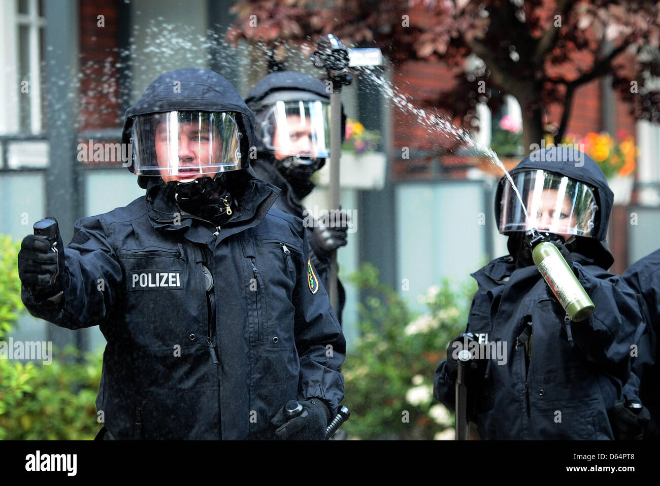 Police officers use pepper spray during a blockade of demonstrators ...