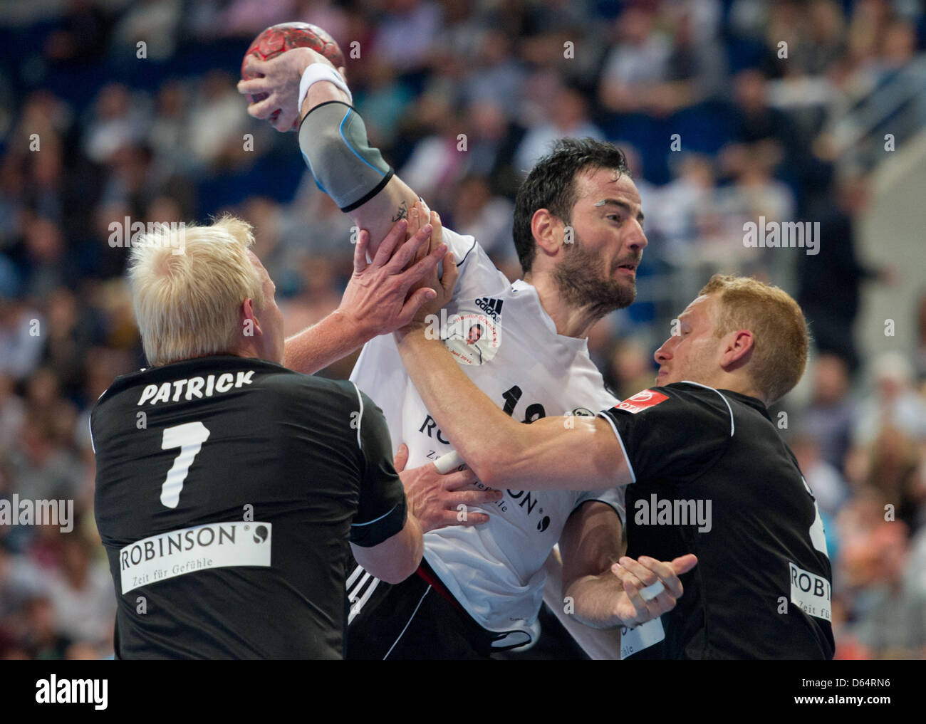 Iker Romero (C) jumops to shoot against Patrick Wiencek (L) and Steffen ...
