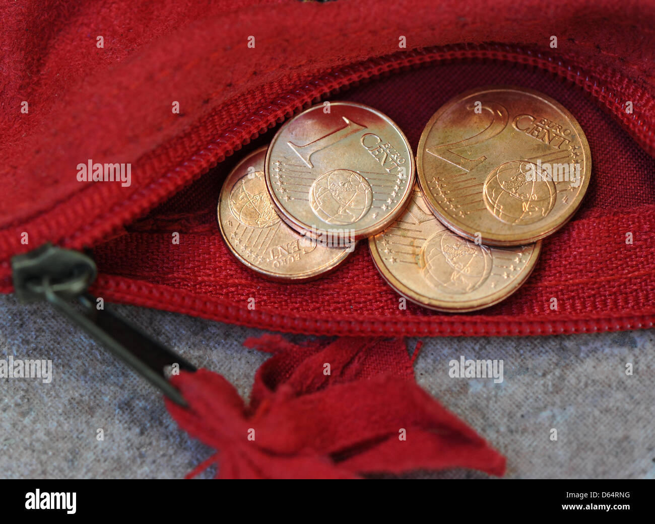 A illustration shows one and two euro cent coins in a wallet pictured ...